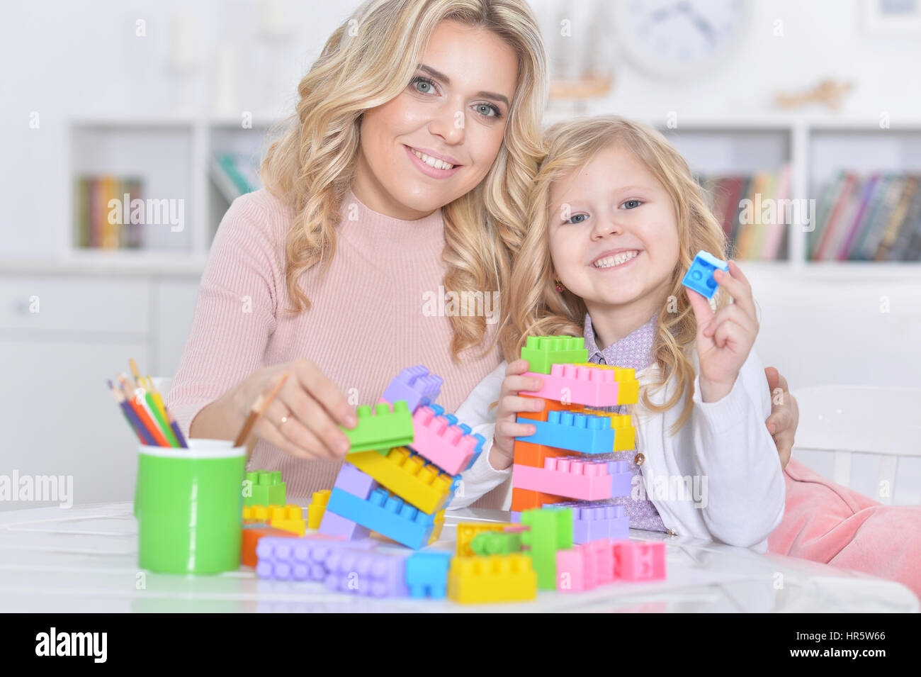 young mother and little daughter playing lego game Stock Photo - Alamy