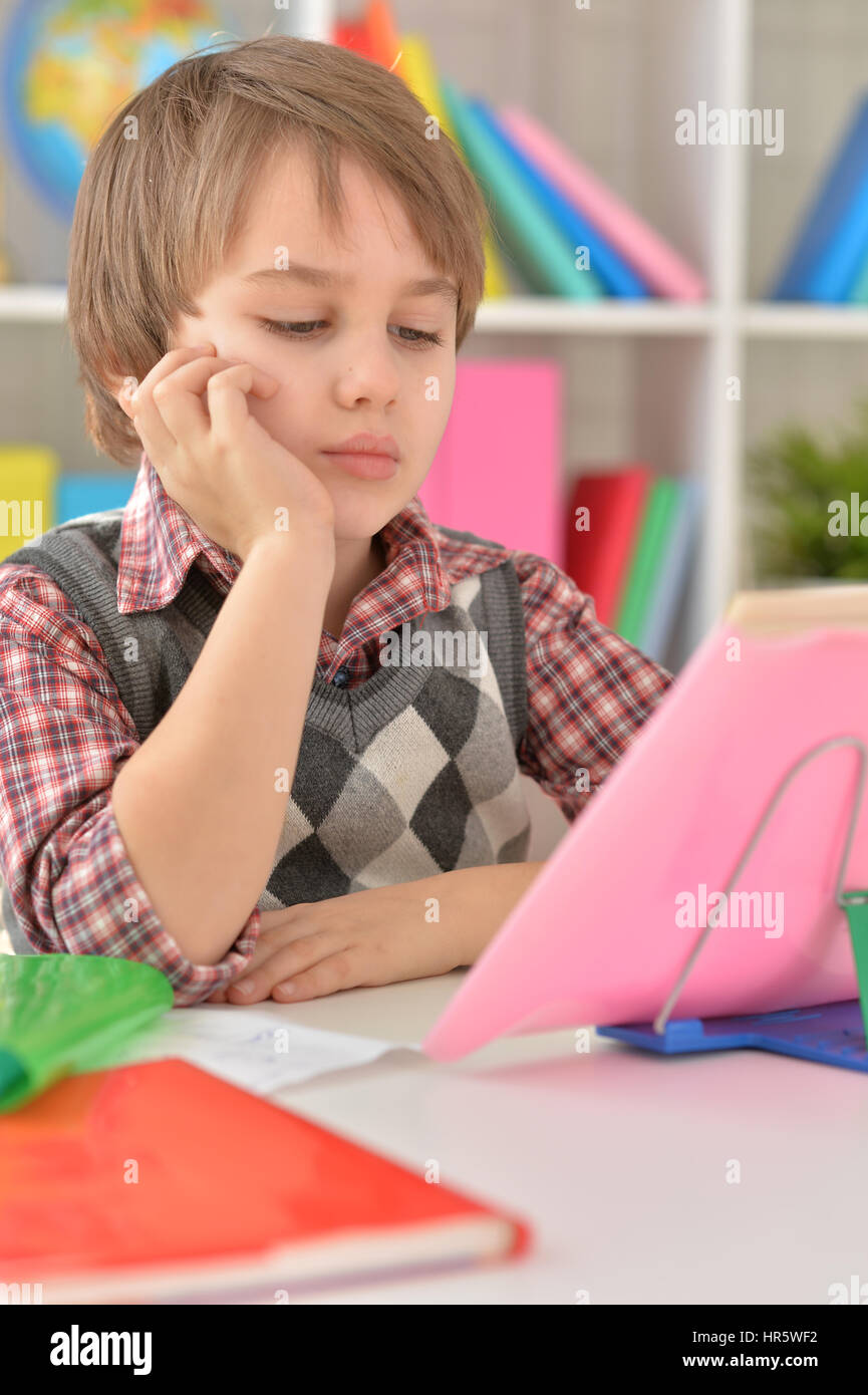 Portrait of a concentrated little boy doing his homework Stock Photo ...
