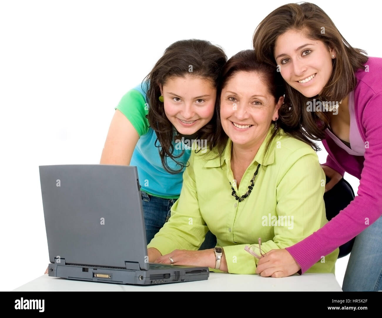 family on a laptop computer smiling - isolated over a white background ...