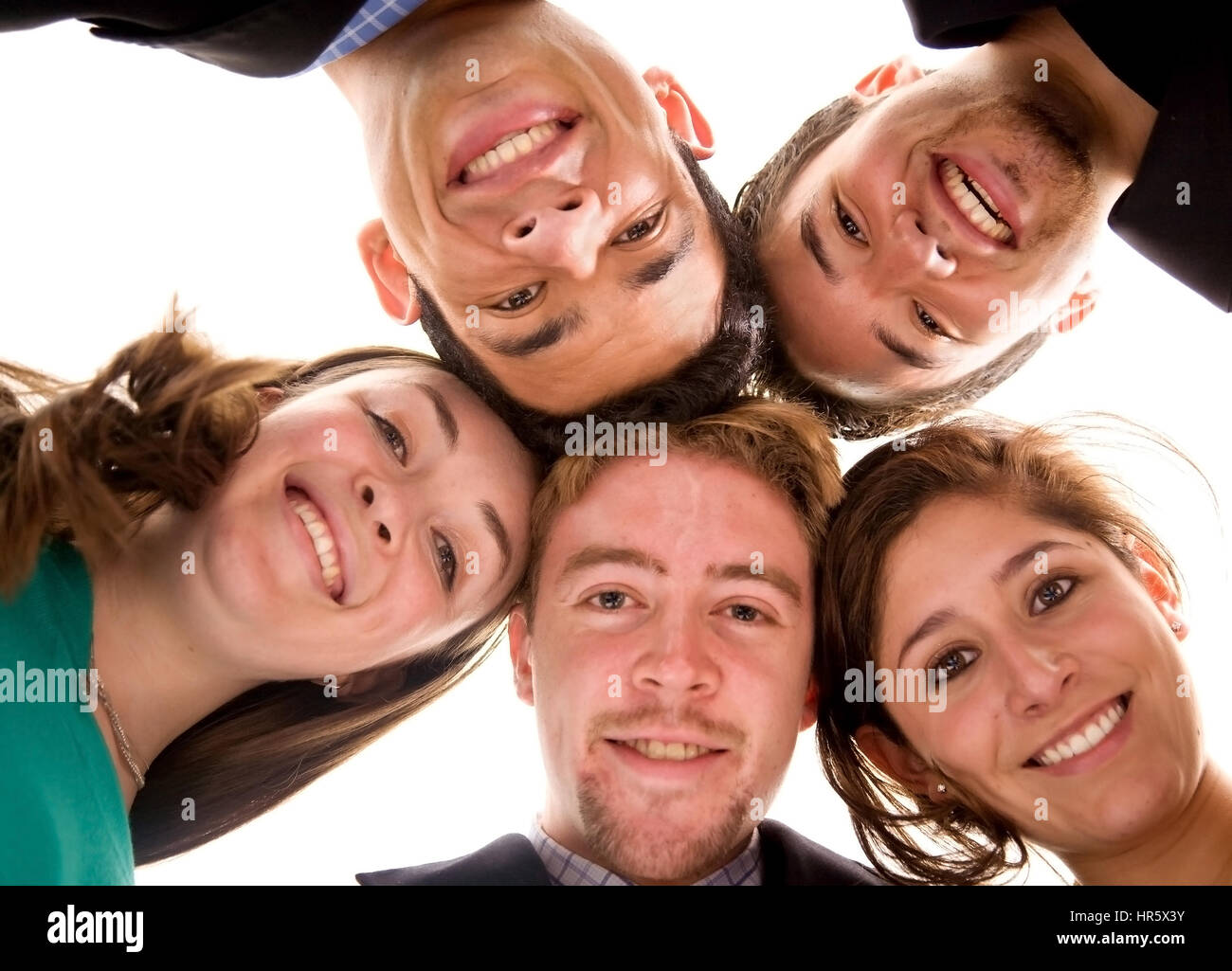 business team with their heads together over a white background Stock ...