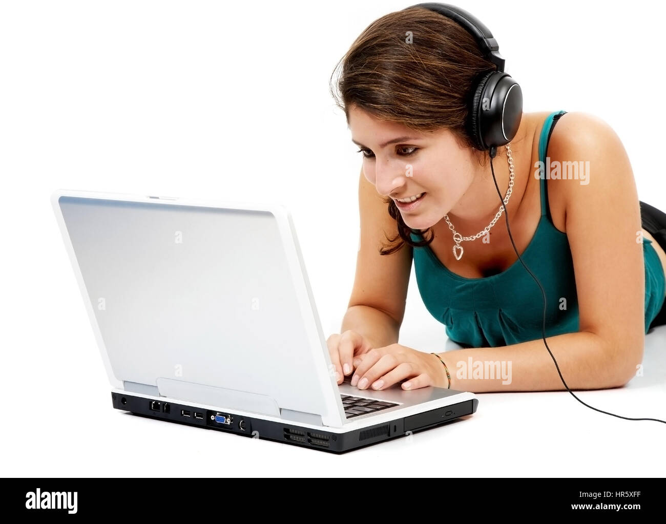 Casual student listening to music on the computer while studying ...