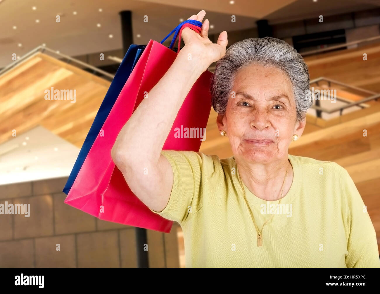 beautiful senior doing some shopping in a shopping mall Stock Photo - Alamy