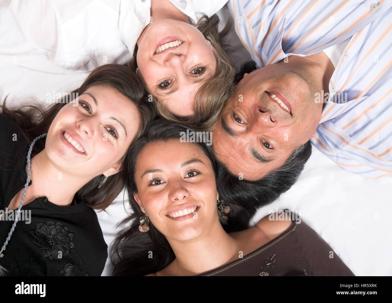 beautiful family - heads together on the floor Stock Photo - Alamy