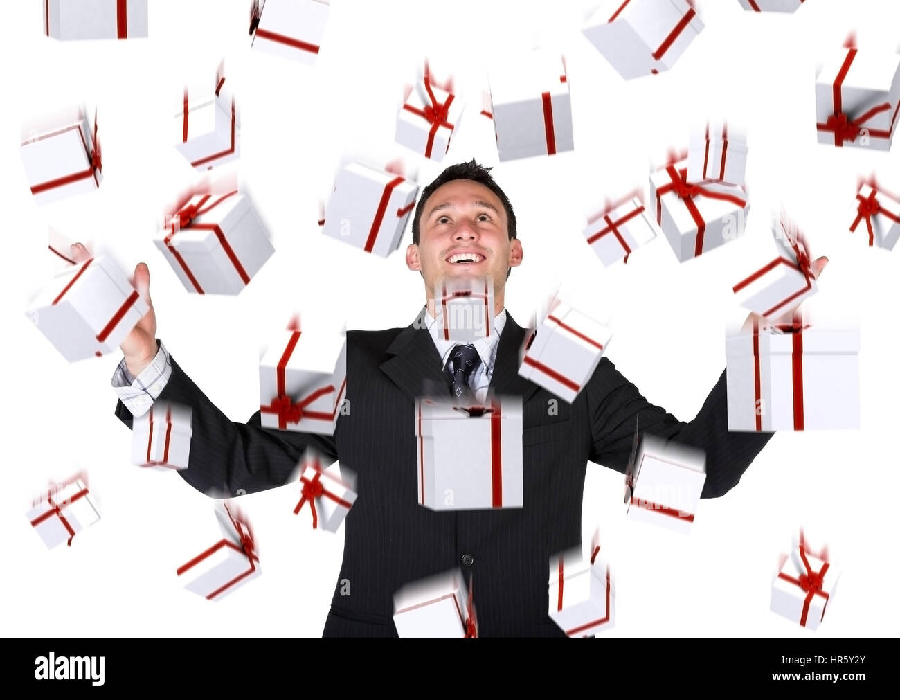 gifts falling down on a business man over a white background Stock ...