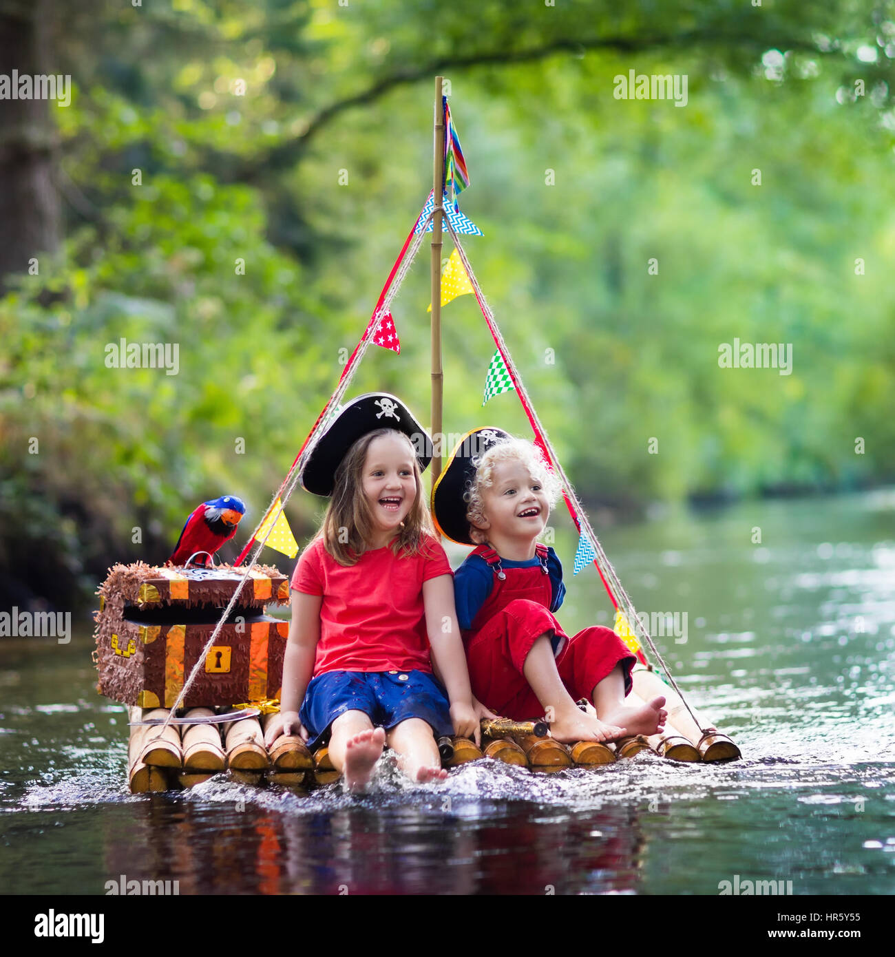Kids dressed in pirate costumes and hats with treasure chest ...