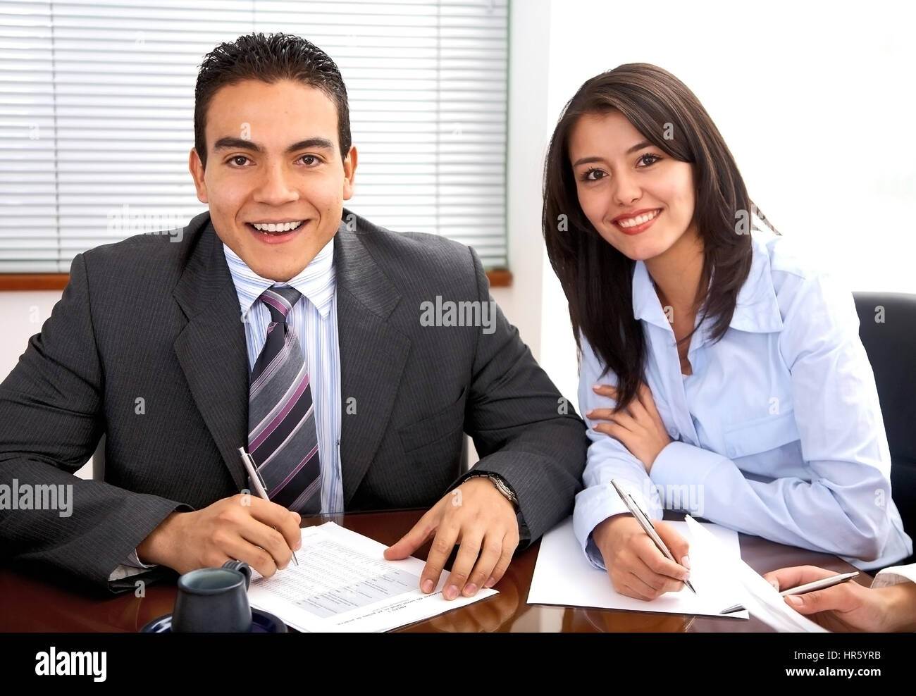 business woman with her partner in an office smiling Stock Photo - Alamy