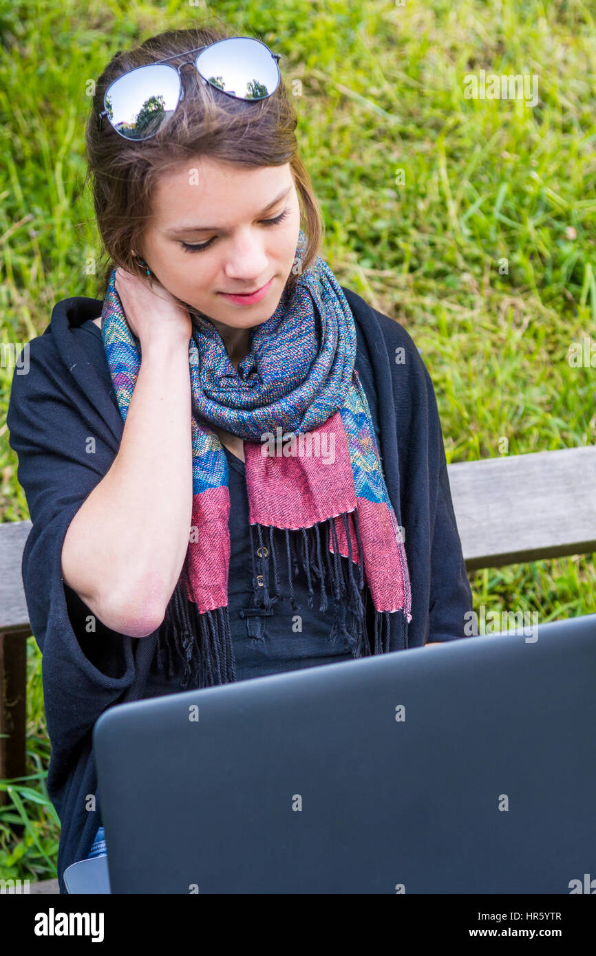 Young Woman Rubbing Her Neck While Working On A Laptop Millenial 5822