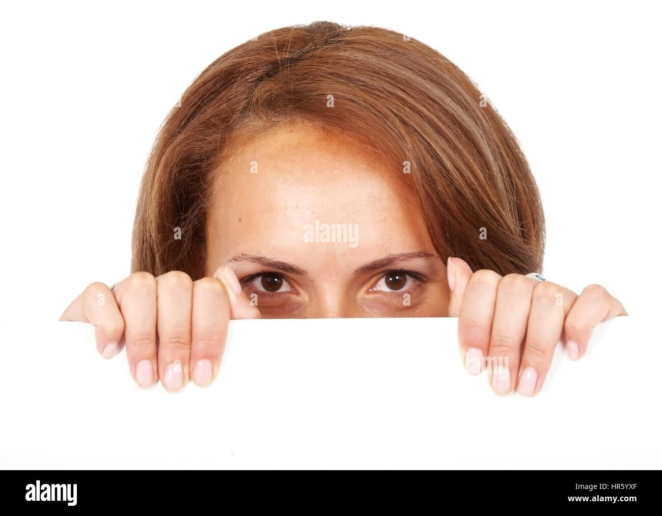 casual woman peeping over billboard sign isolated over a white ...