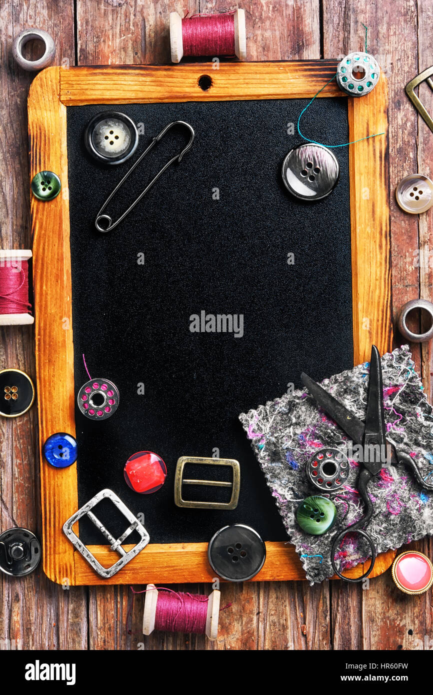 Set of buttons and thread on the chalk board for drawing.Copy space ...