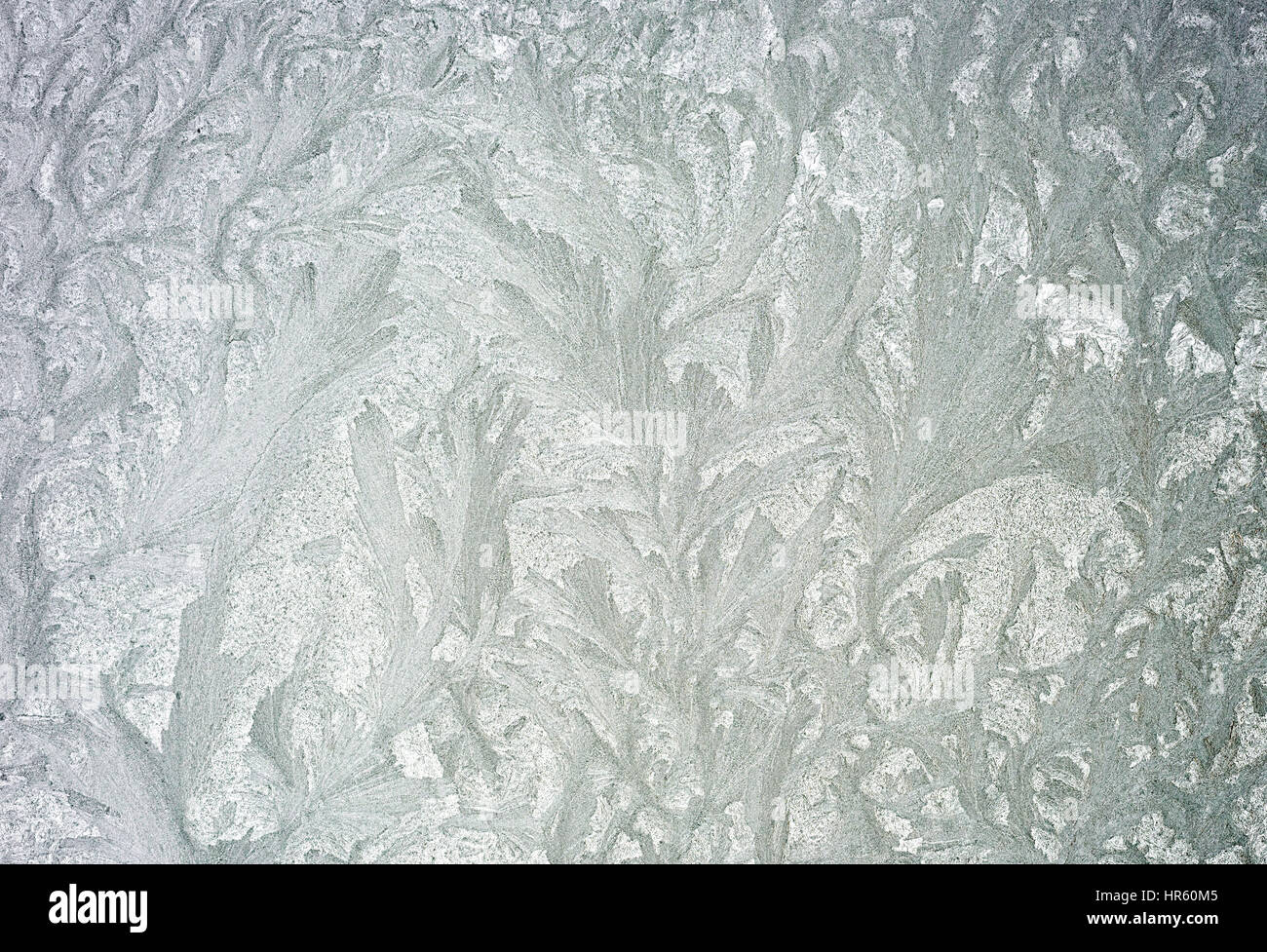 Frosted ice on a glass window creates a winter themed pattern Stock ...