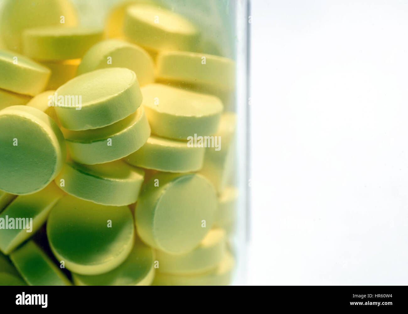 Yellow medical pills in a plastic jar with a screw cap top in ...