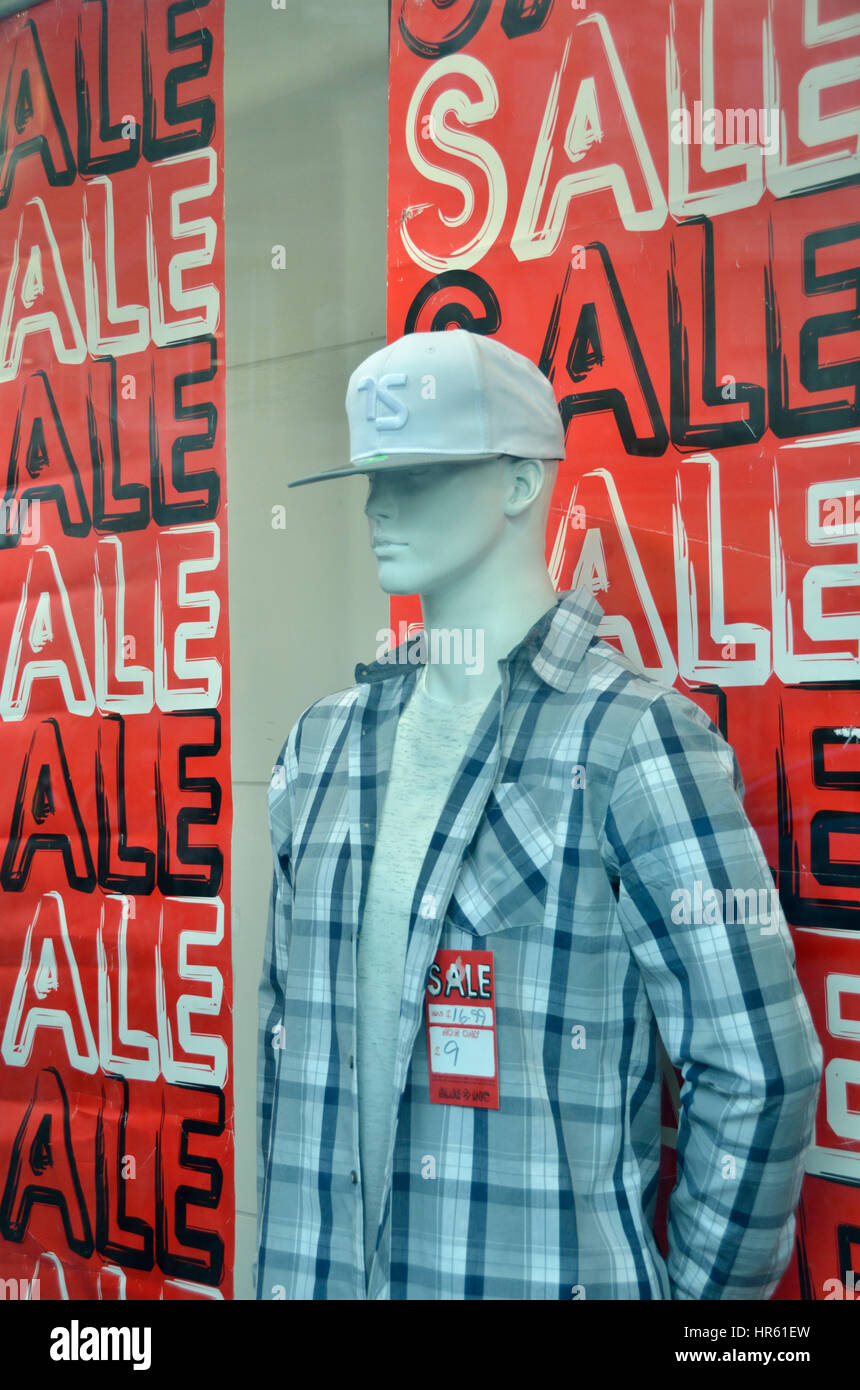 Mannequin and red sale sign in a UK High Street shop window Stock Photo ...