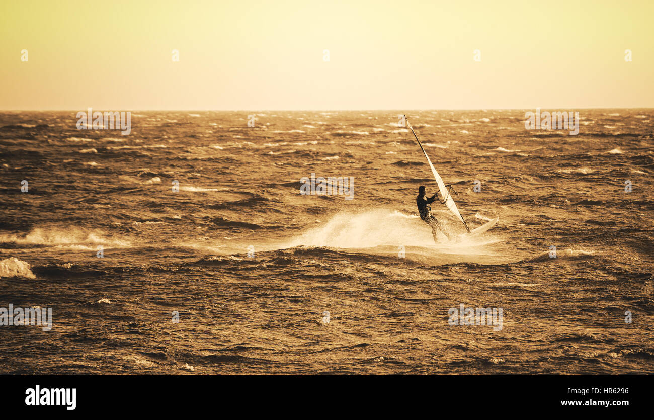 windsurfing at sunset Stock Photo - Alamy