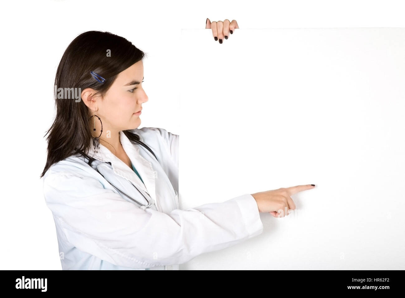 friendly female doctor over white pointing at a white card Stock Photo ...