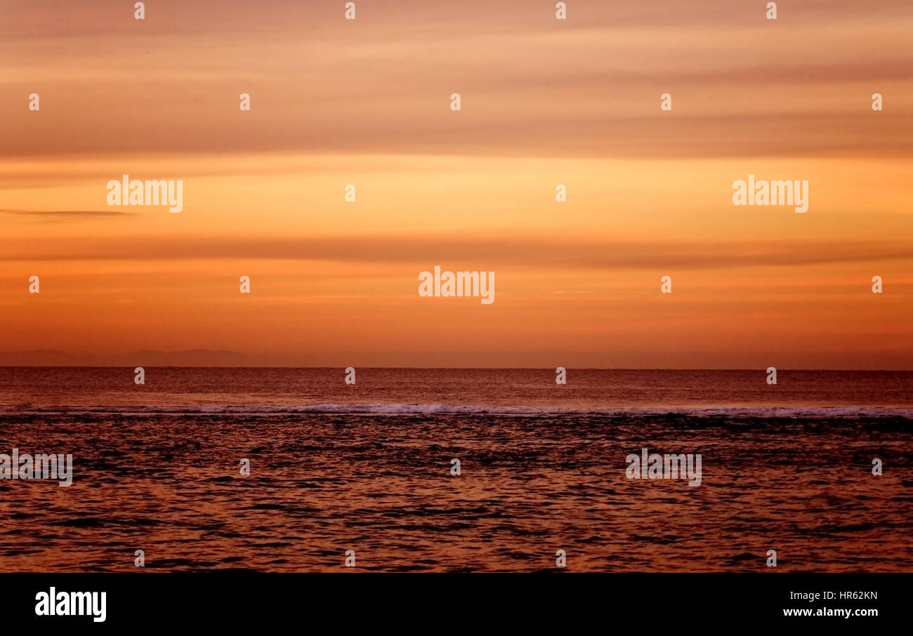 beautiful sunset by the beach in orange colours Stock Photo - Alamy