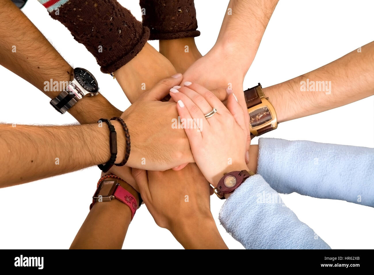 team with arms together in cooperation to look for success - isolated ...