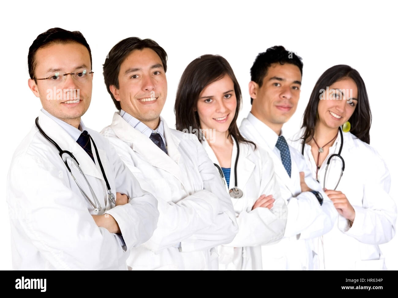 friendly young doctors smiling over a white background - focus is on ...
