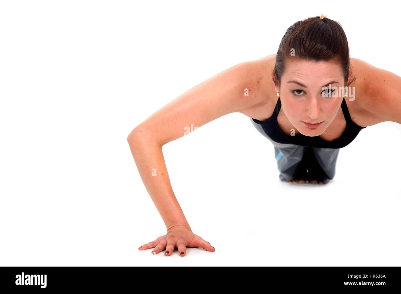 girl doing exercise - push ups over a white background Stock Photo - Alamy