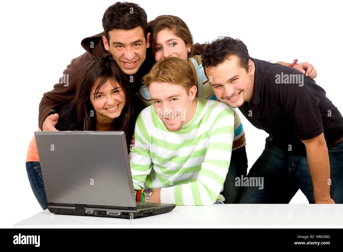 Casual group of happy students with a laptop - isolated over a white ...