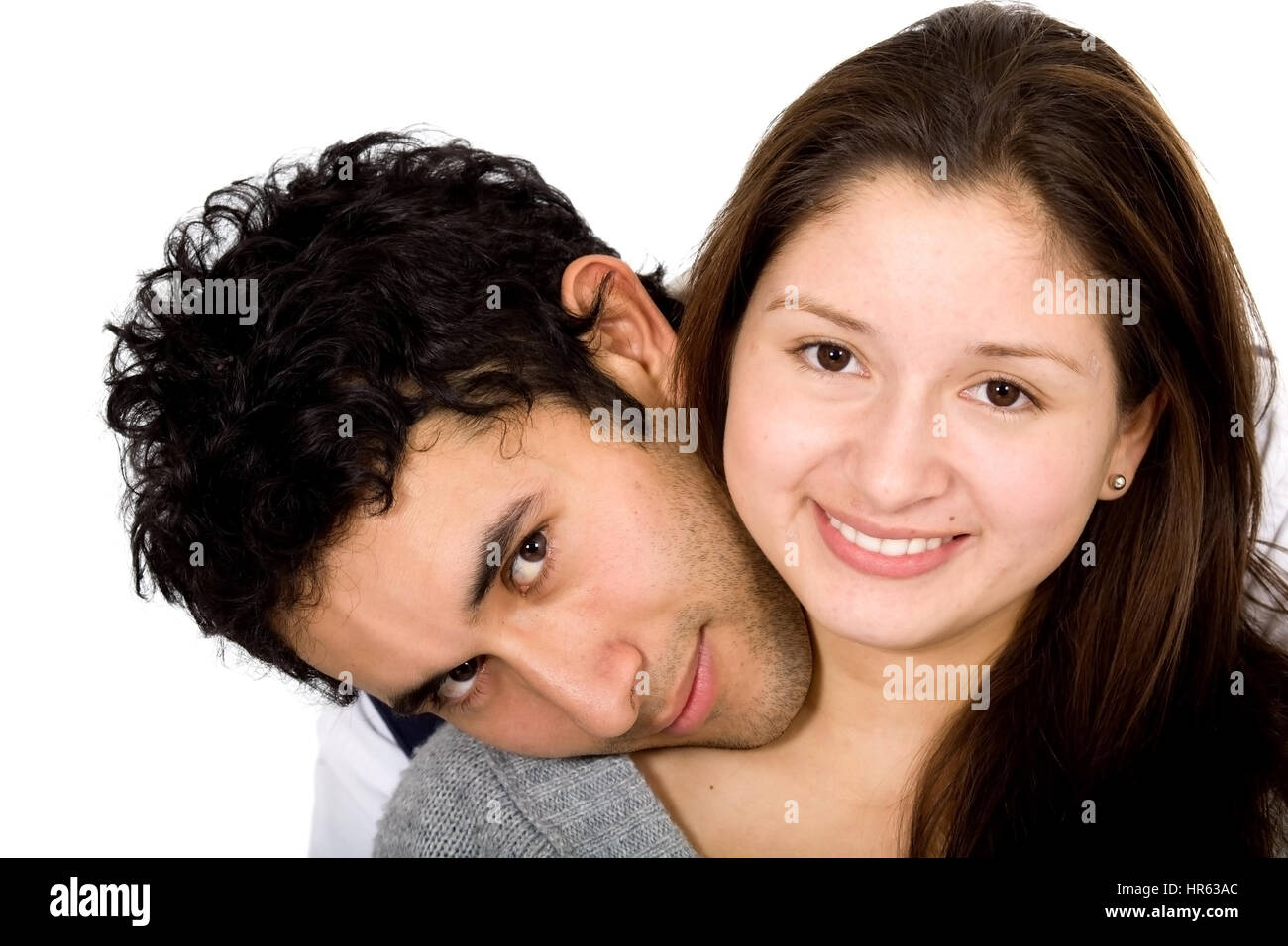 beautiful and cute couple portrait where both are smiling over a white ...