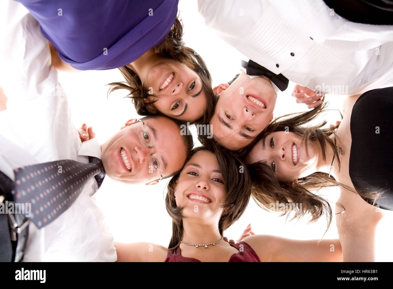 cheerful friends smiling and laughing together over a white background ...