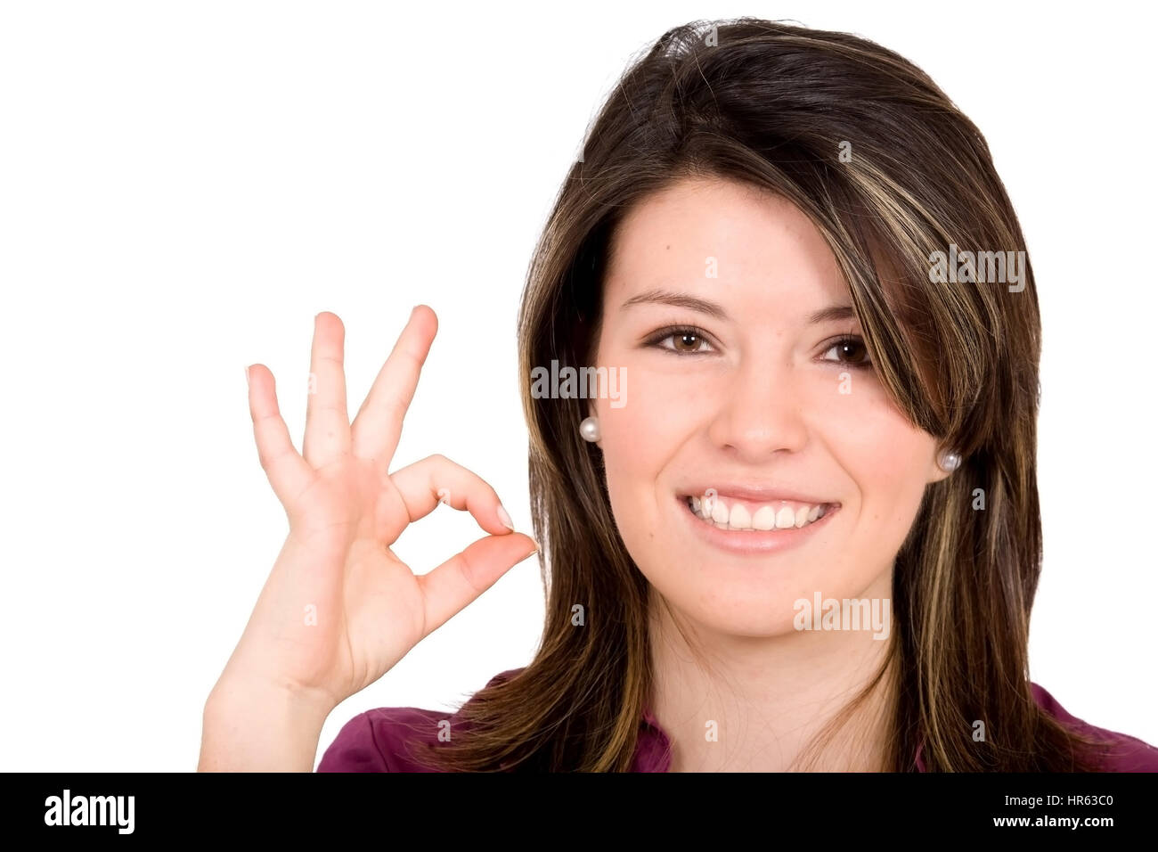 girl doing okay sign and smiling over a white background Stock Photo ...