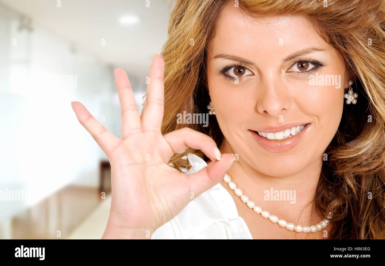 business woman doing the ok sign in an office Stock Photo - Alamy
