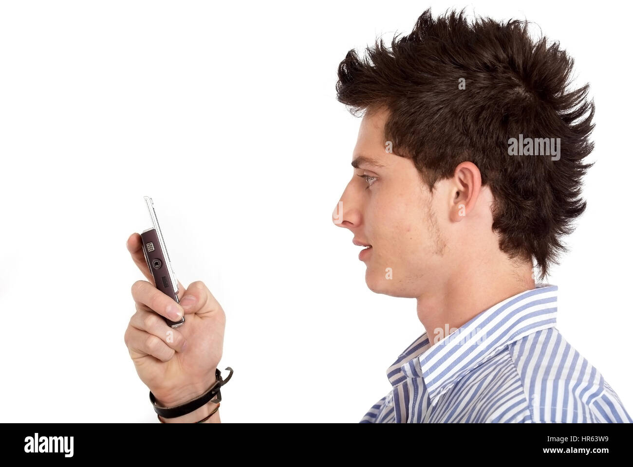 casual man texting on the phone smiling - isolated over a white ...