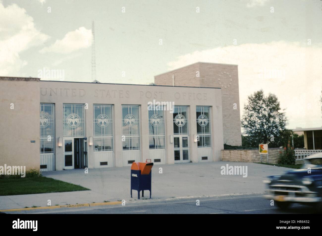 The exterior of a United States Post Office building that has logos on ...