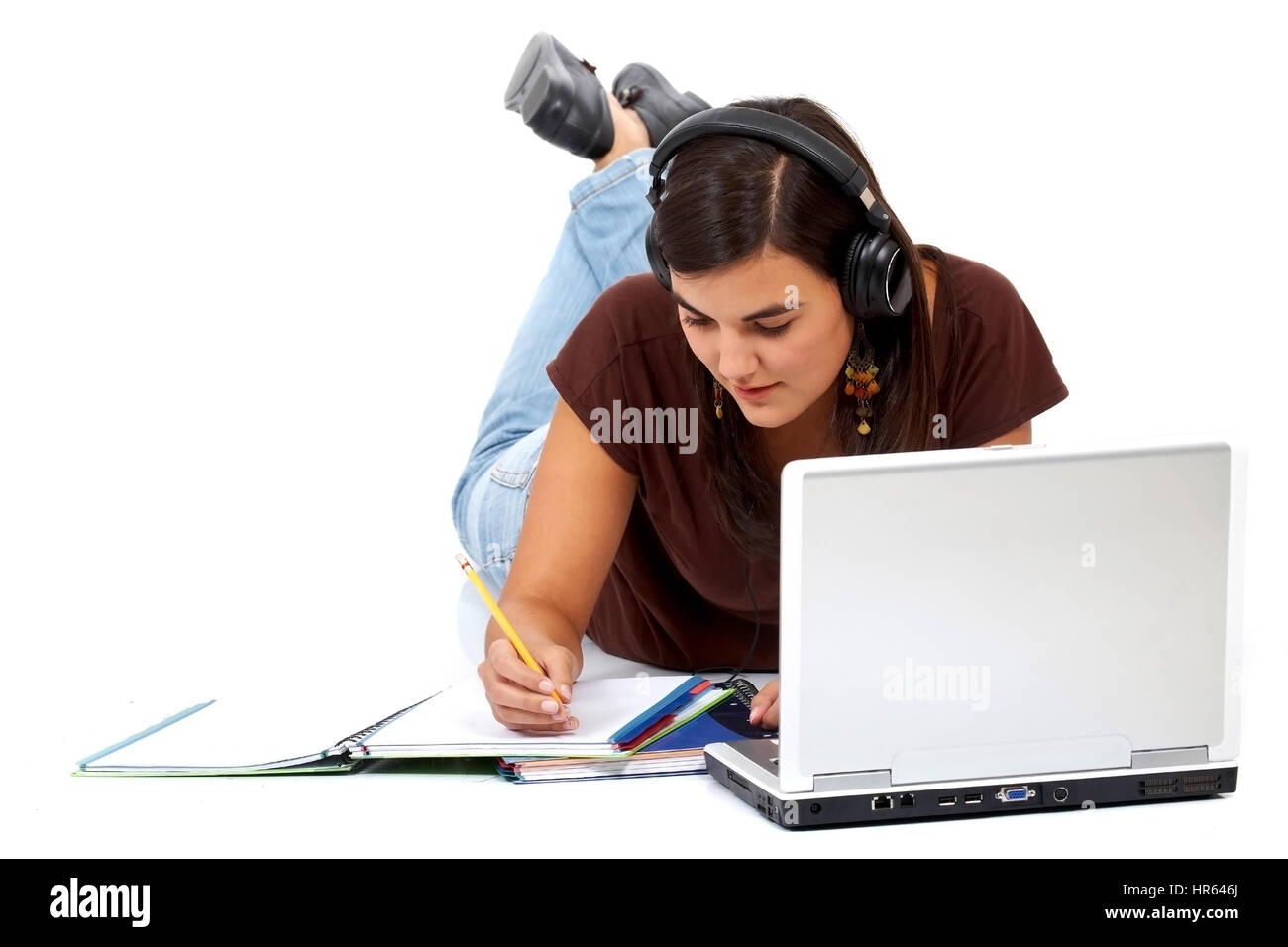 college girl studying with some notebooks and a laptop computer ...