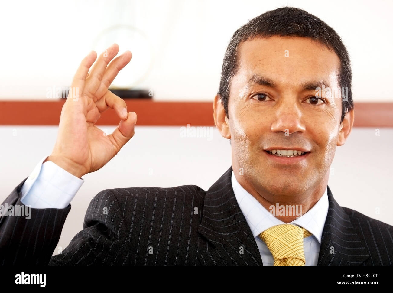 business man smiling doing the ok sign in his office Stock Photo - Alamy