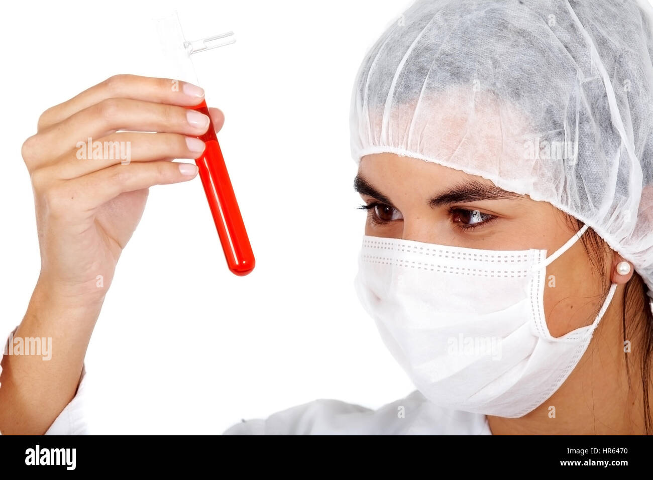 doctor examining a blood sample in a test tube over a white background ...