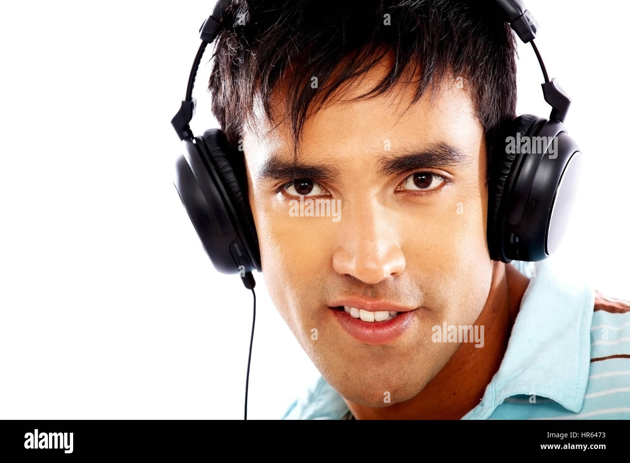 man looking happy listening to music on his headphones isolated over a ...
