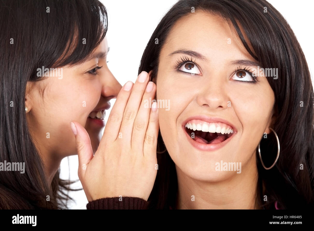 girl telling a secret to another - gossip isolated over a white ...