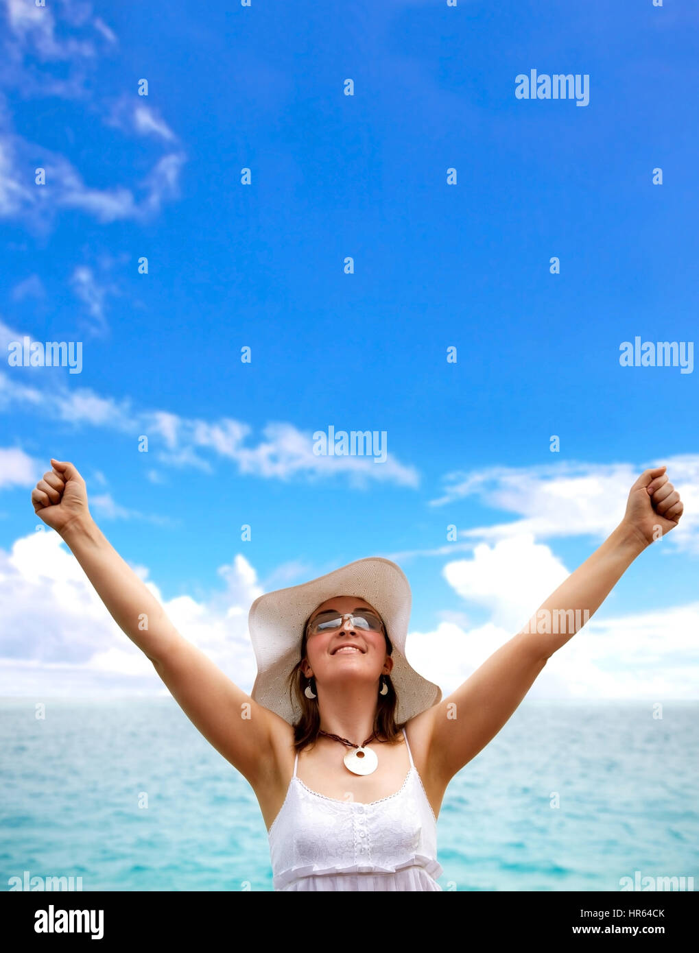 beach woman success with arms open in front of the sea Stock Photo - Alamy