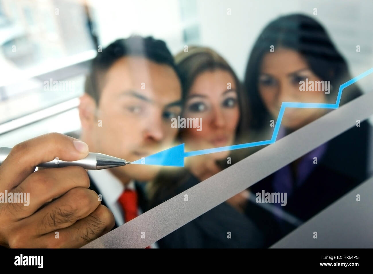 business team in an office showing their success on a graph Stock Photo ...