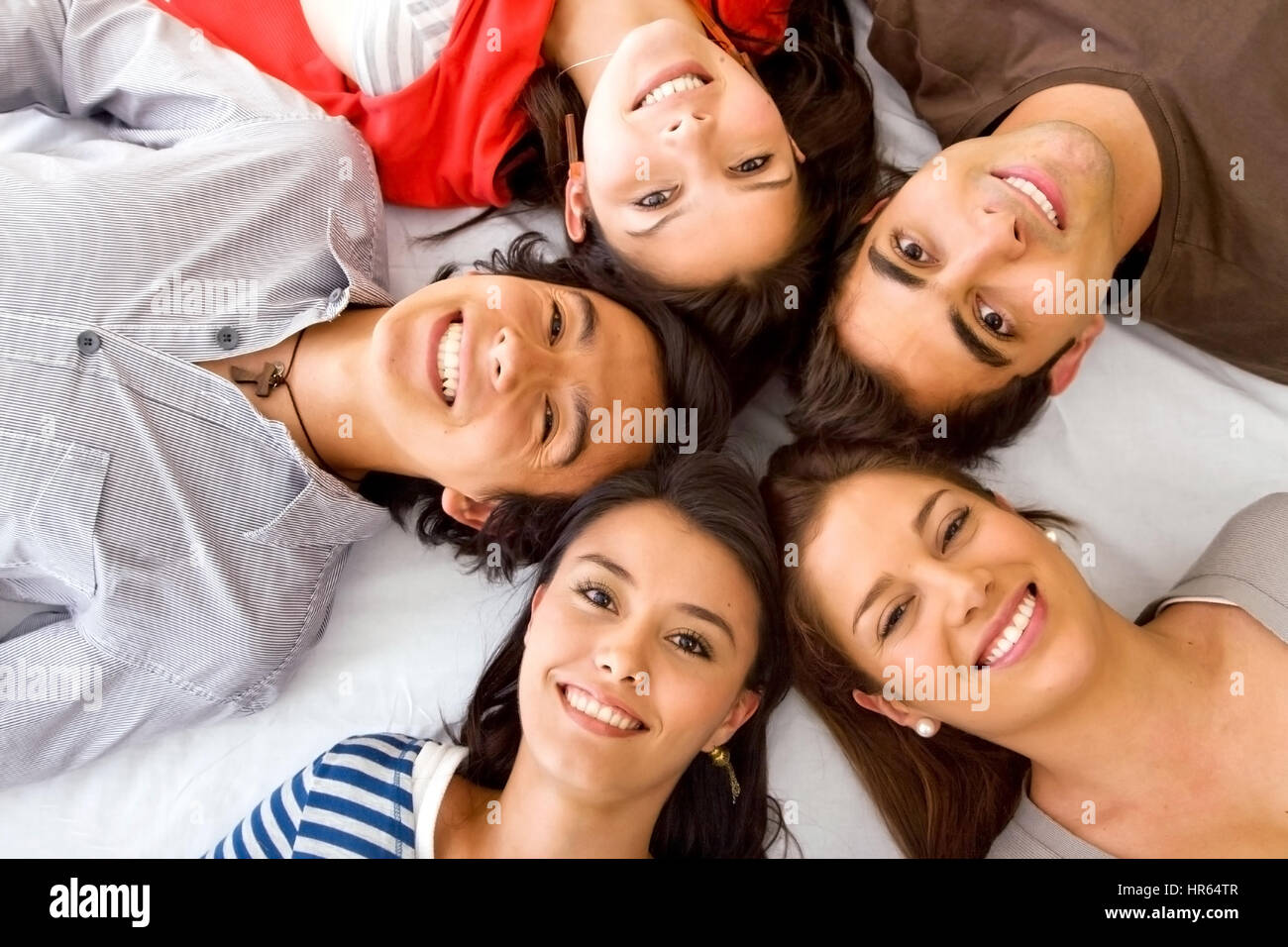 happy group of friends together on the floor Stock Photo - Alamy