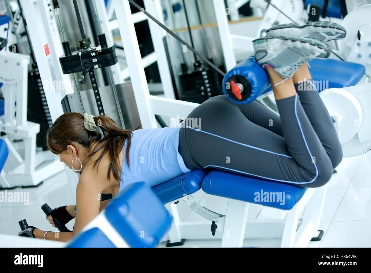 woman at the gym doing back exercises on a machine Stock Photo - Alamy