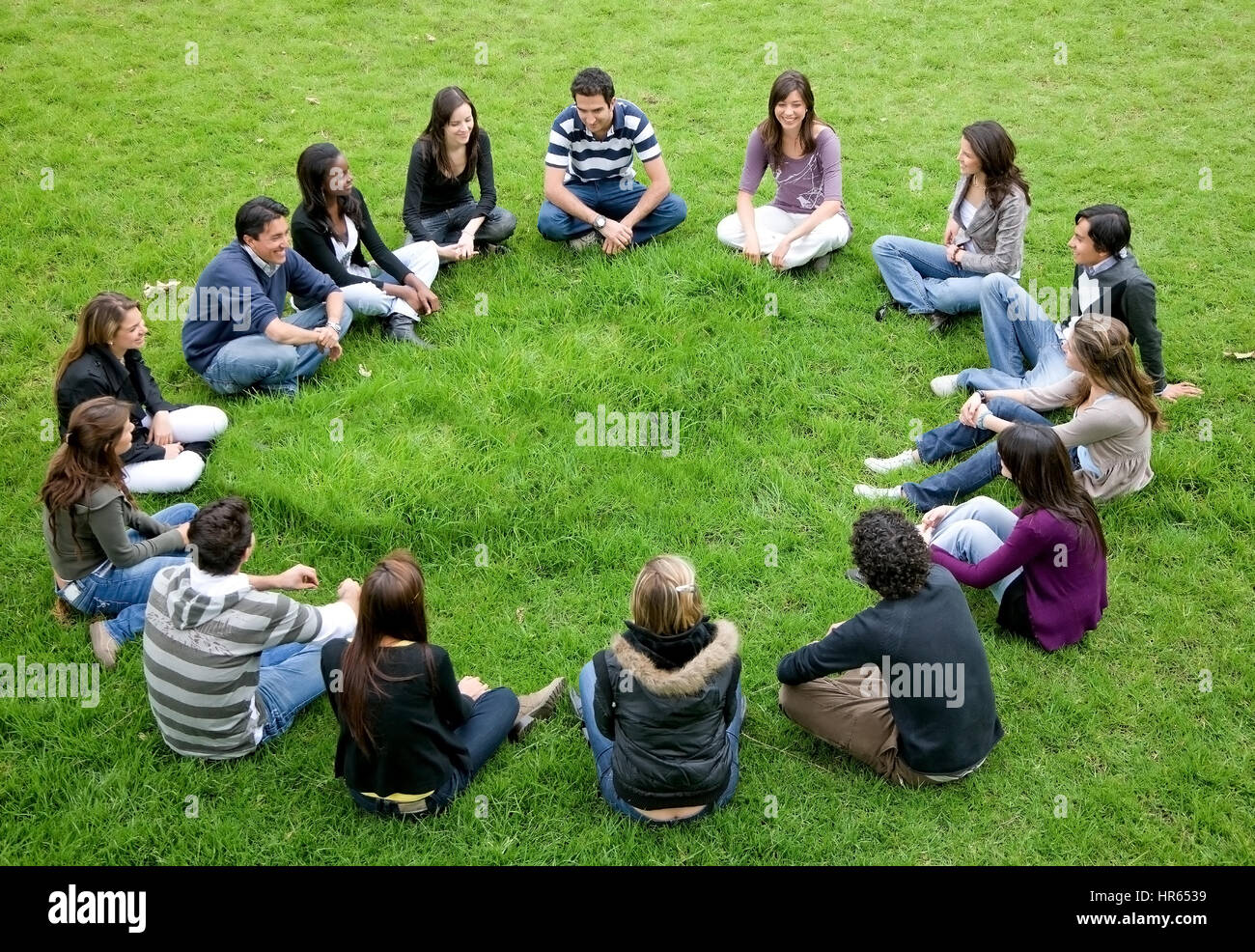 happy group of friends in a circle outdoors in a park Stock Photo - Alamy