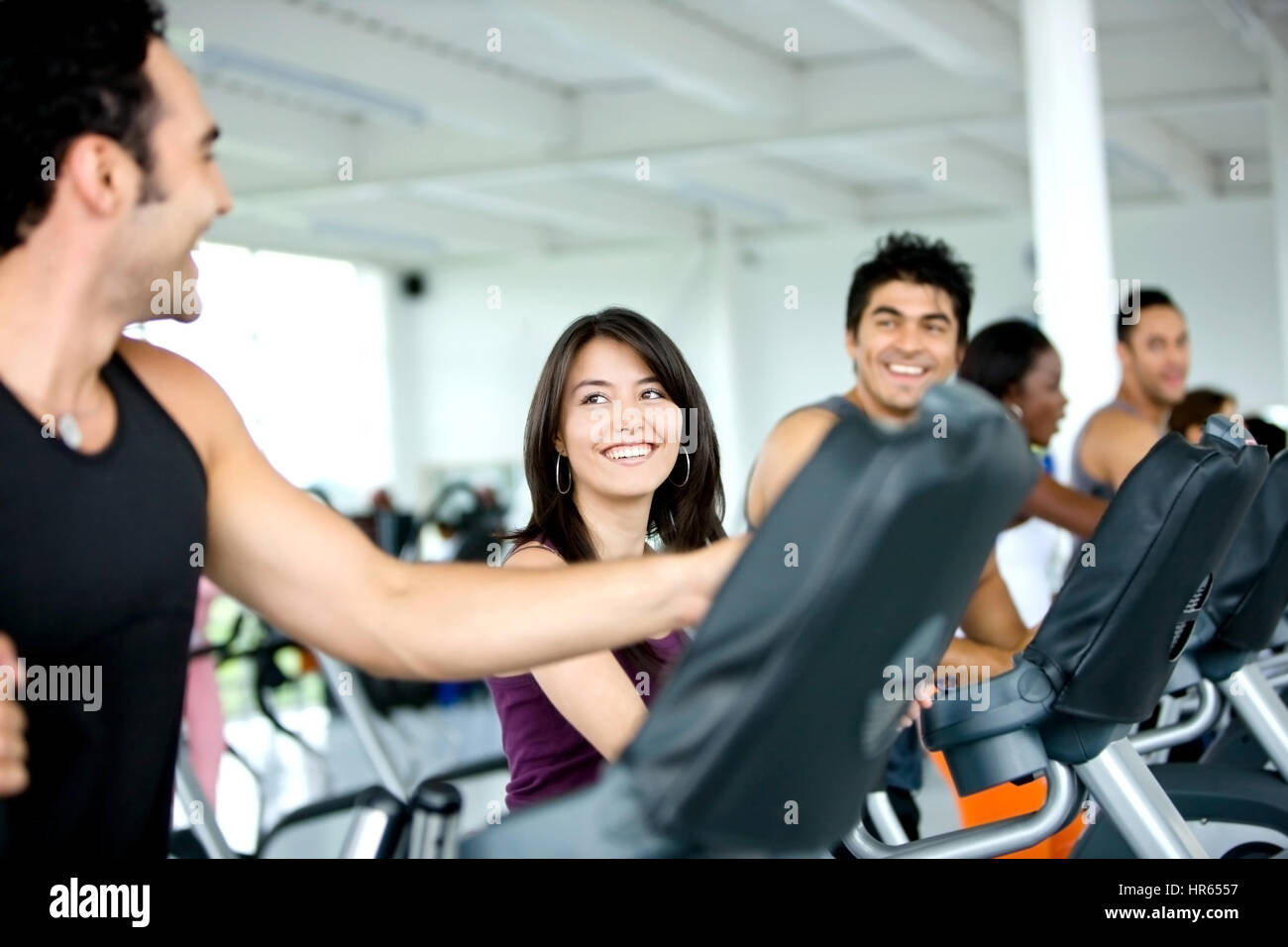 Group of friends laughing while exercising at a gym Stock Photo - Alamy
