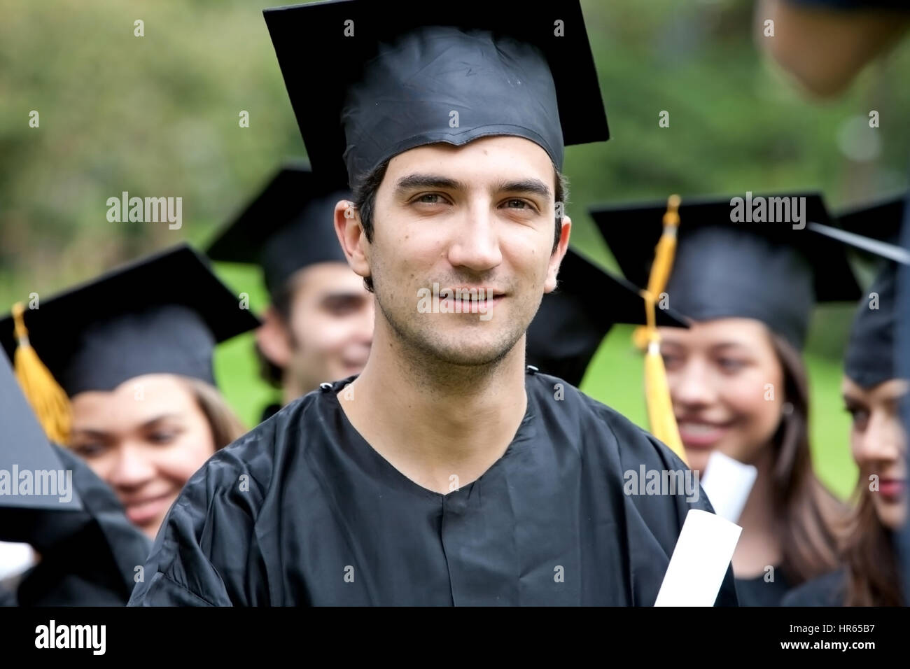 graduation man portrait smiling and looking happy outdoors Stock Photo ...