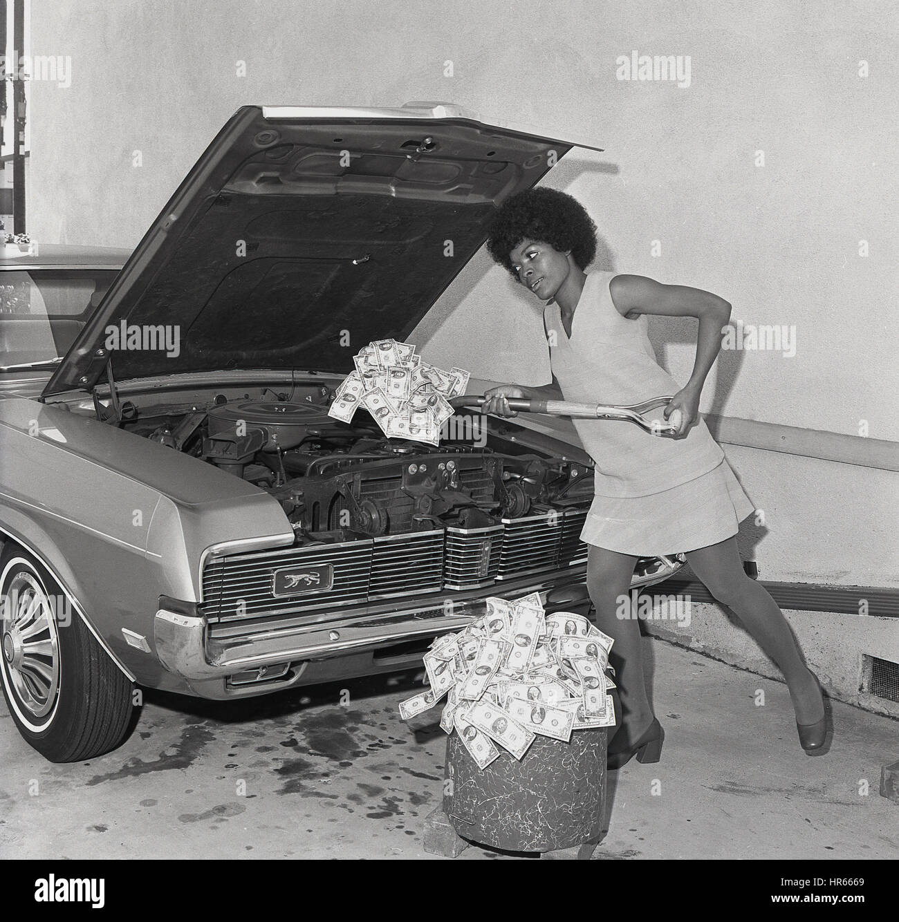 1960s, historical, 'owning a car is a real money pit'...car in garage ...