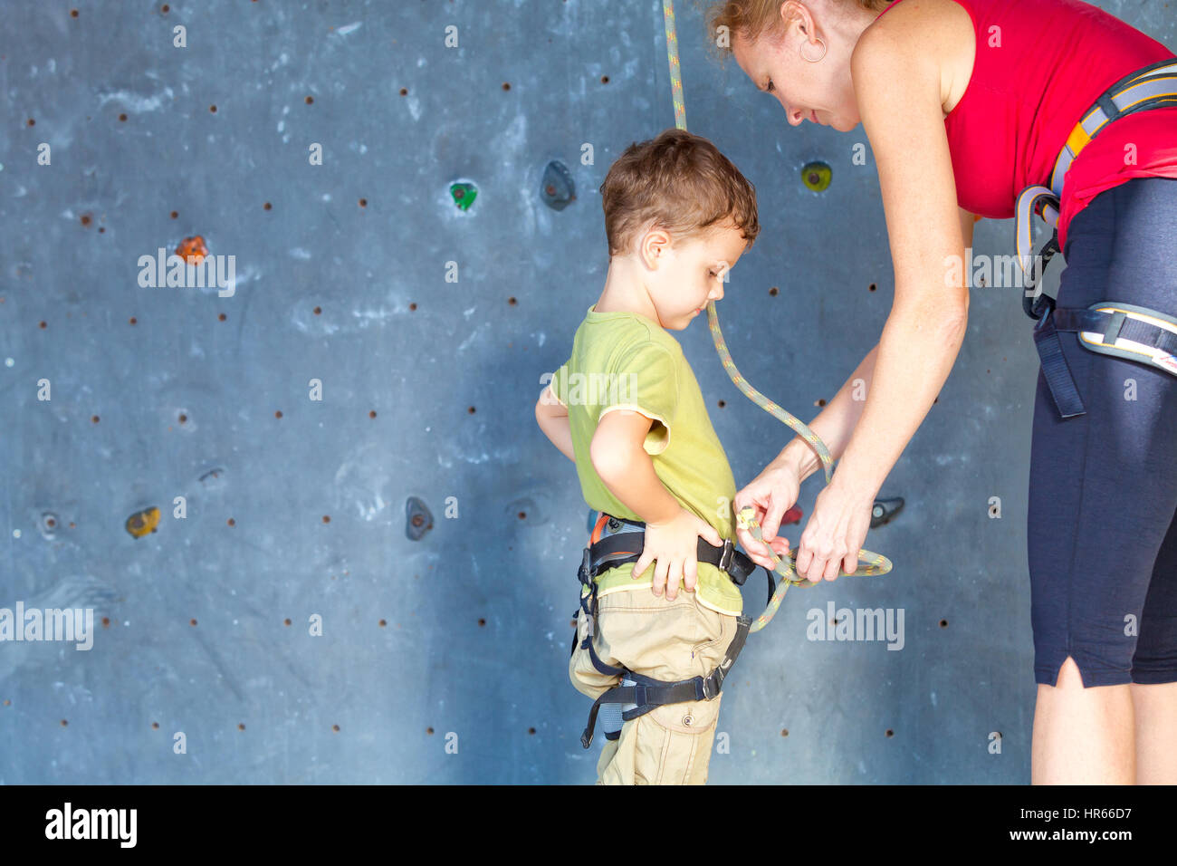 little boy climbing a rock wall indoor Stock Photo - Alamy