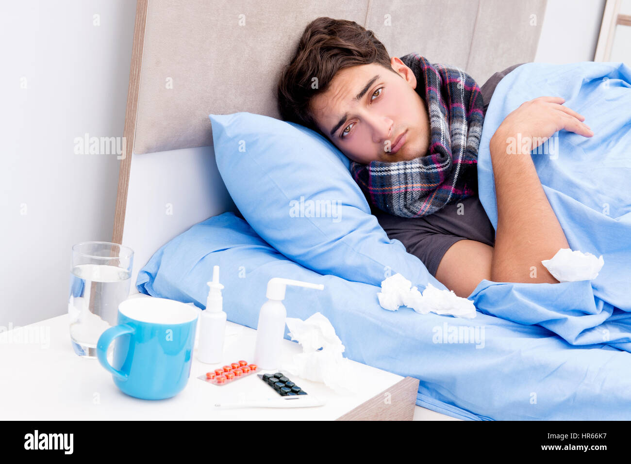 Sick ill man in the bed taking medicines and drugs Stock Photo - Alamy