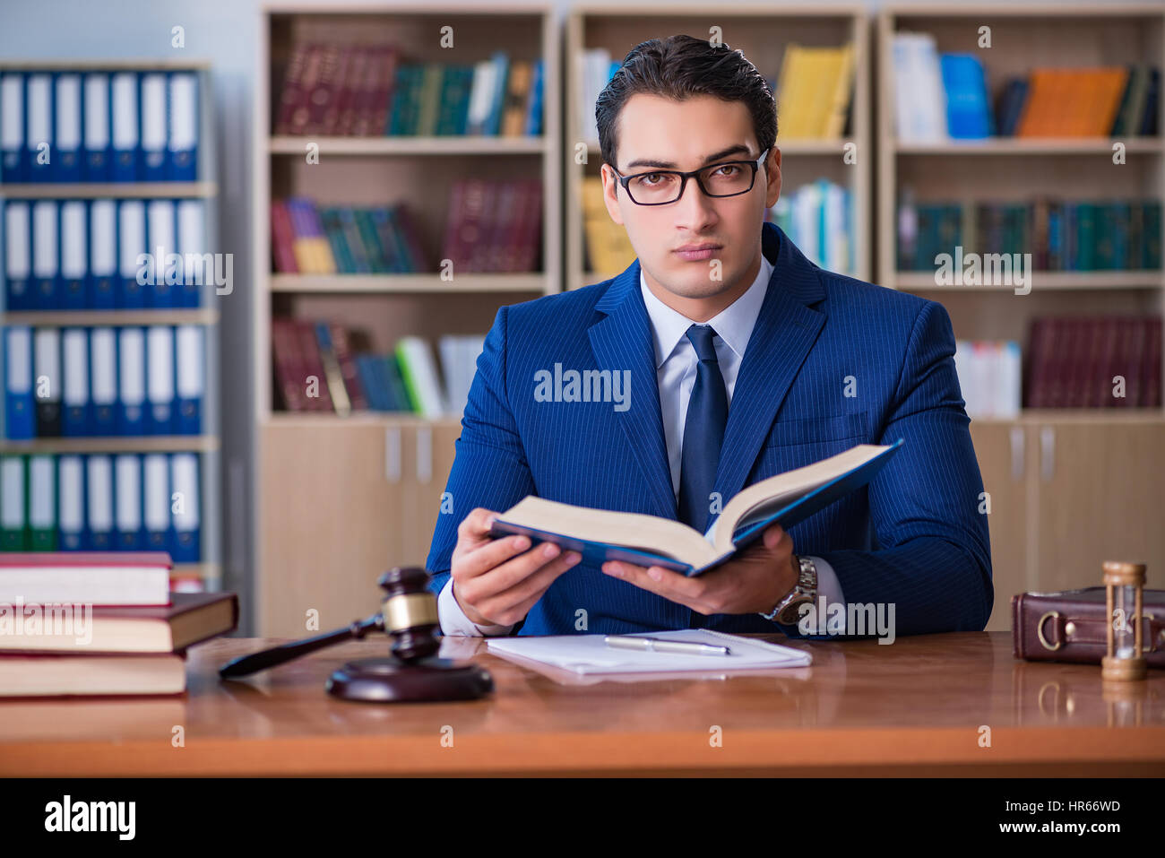 Handsome judge with gavel sitting in courtroom Stock Photo - Alamy