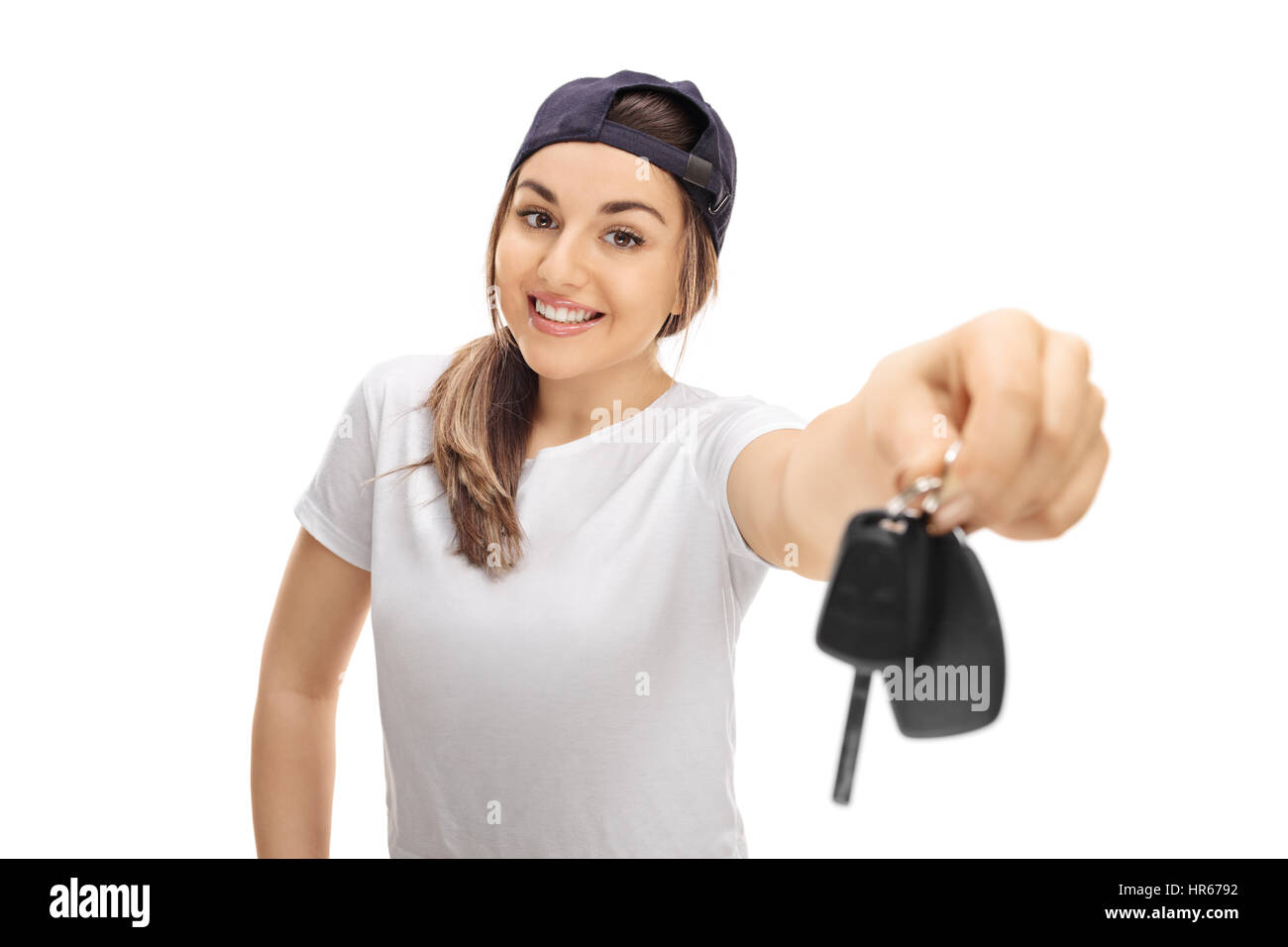 Joyful teenage girl showing a pair of car keys isolated on white ...
