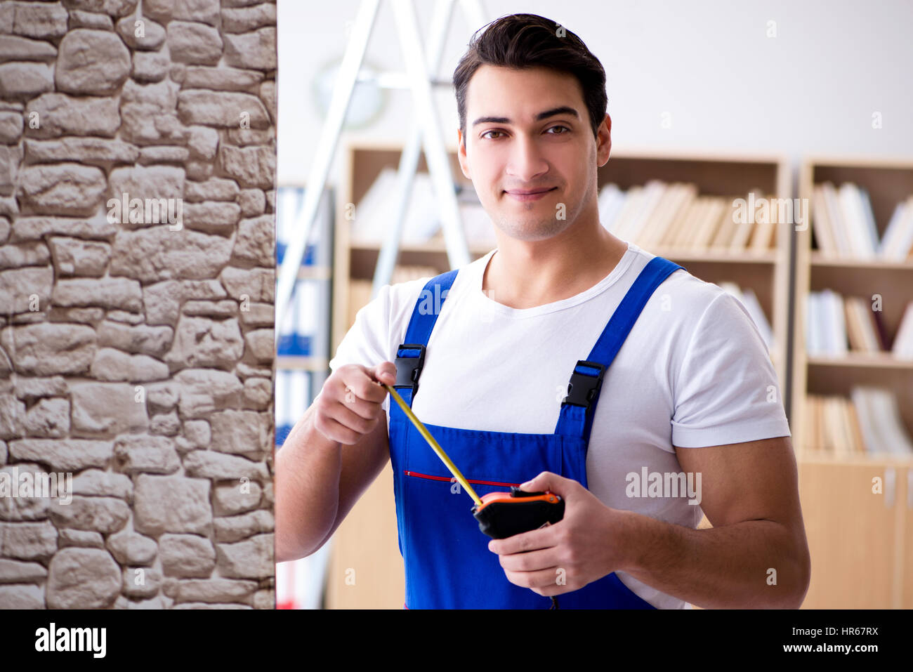 Repairman working with measurement tape Stock Photo - Alamy