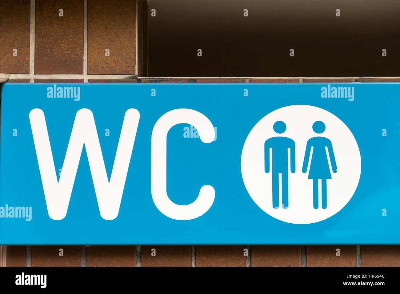 A blue WC sign with male and female symbols Stock Photo - Alamy