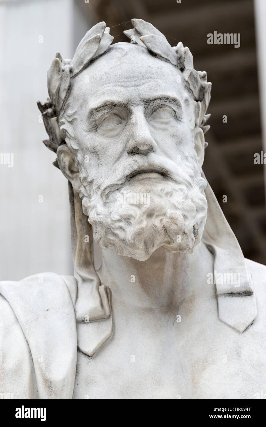 A close up of a marble greek statue adorned with a laurel leaf outside ...