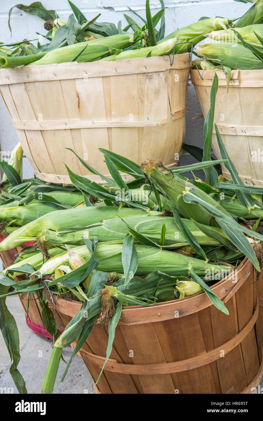 Wood baskets over flowing with corn outside a market Stock Photo - Alamy